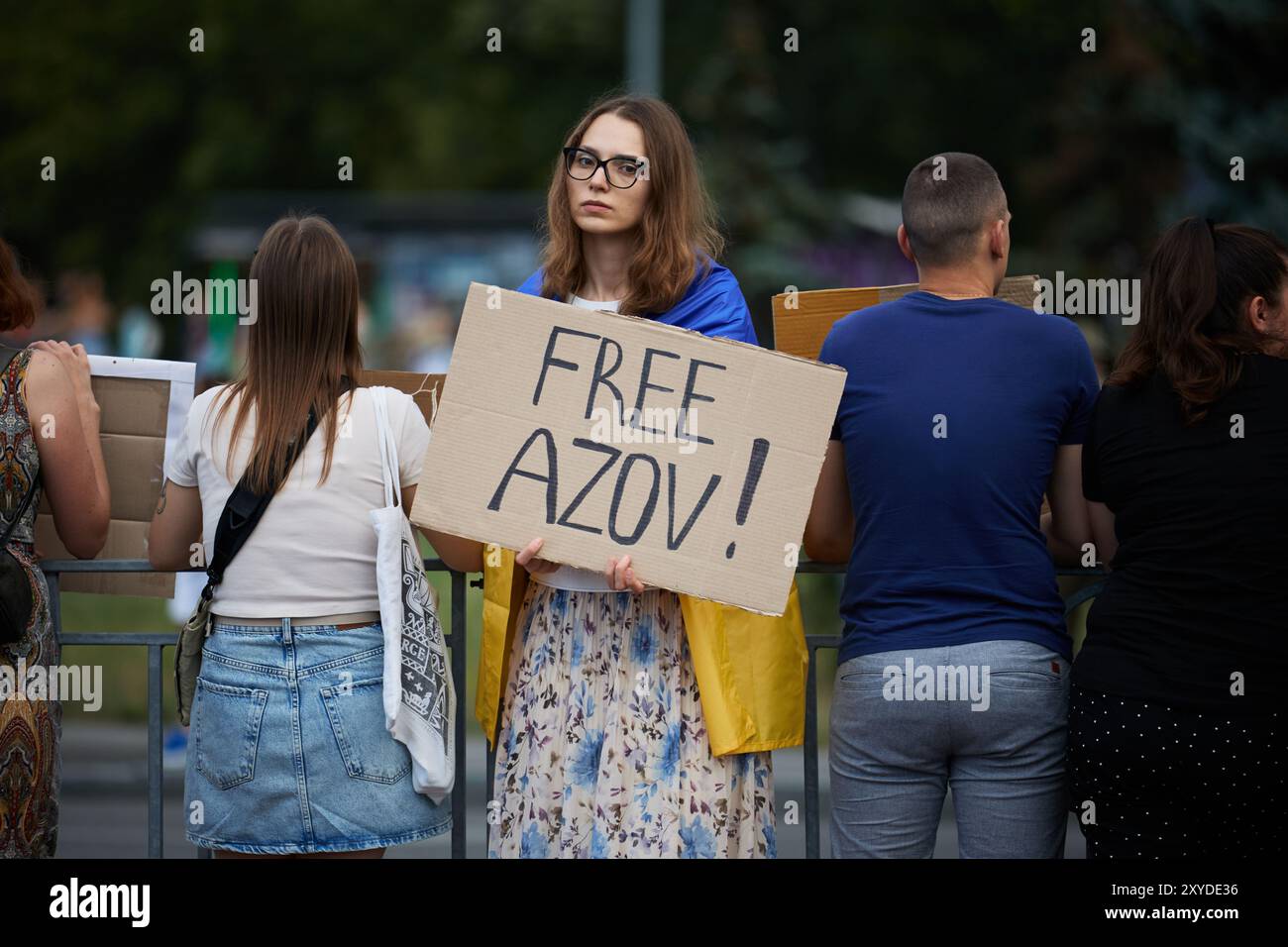 Patriotic Ukrainian girl posing with a sign Free Azov at public protest ...