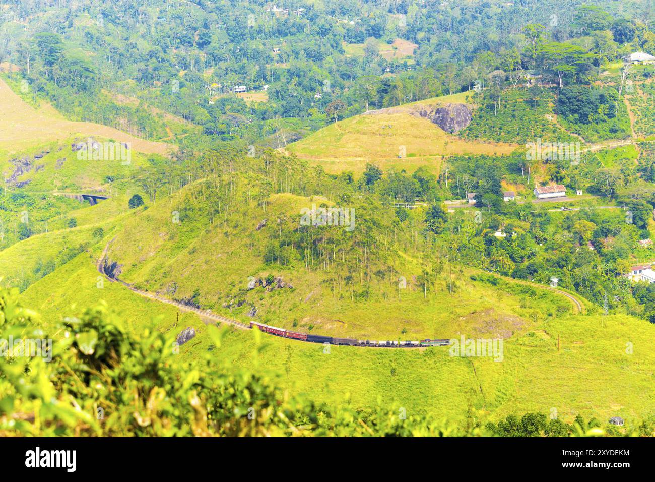 High angle aerial view of train moving along distant Demodara Loop, a ...