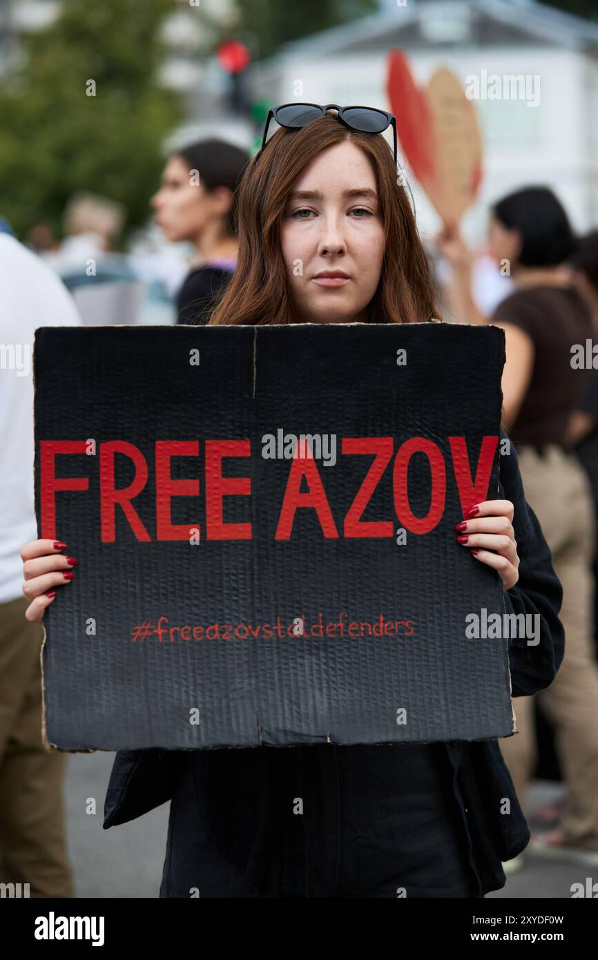 Young woman demonstrating with a sign "Free Azov" at large public action in Kyiv - 18 August ...