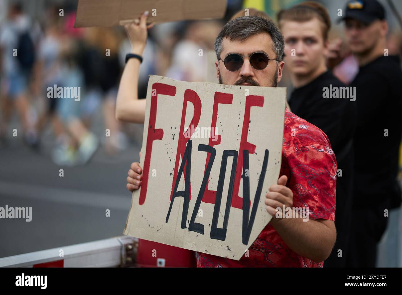 Ukrainian activists demonstrating with a sign "FRee Azov" at rally in ...