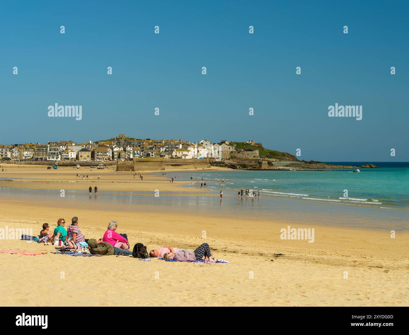 St Ives, Cornwall - On a warm April day, holidaymakers enjoy the sandy ...