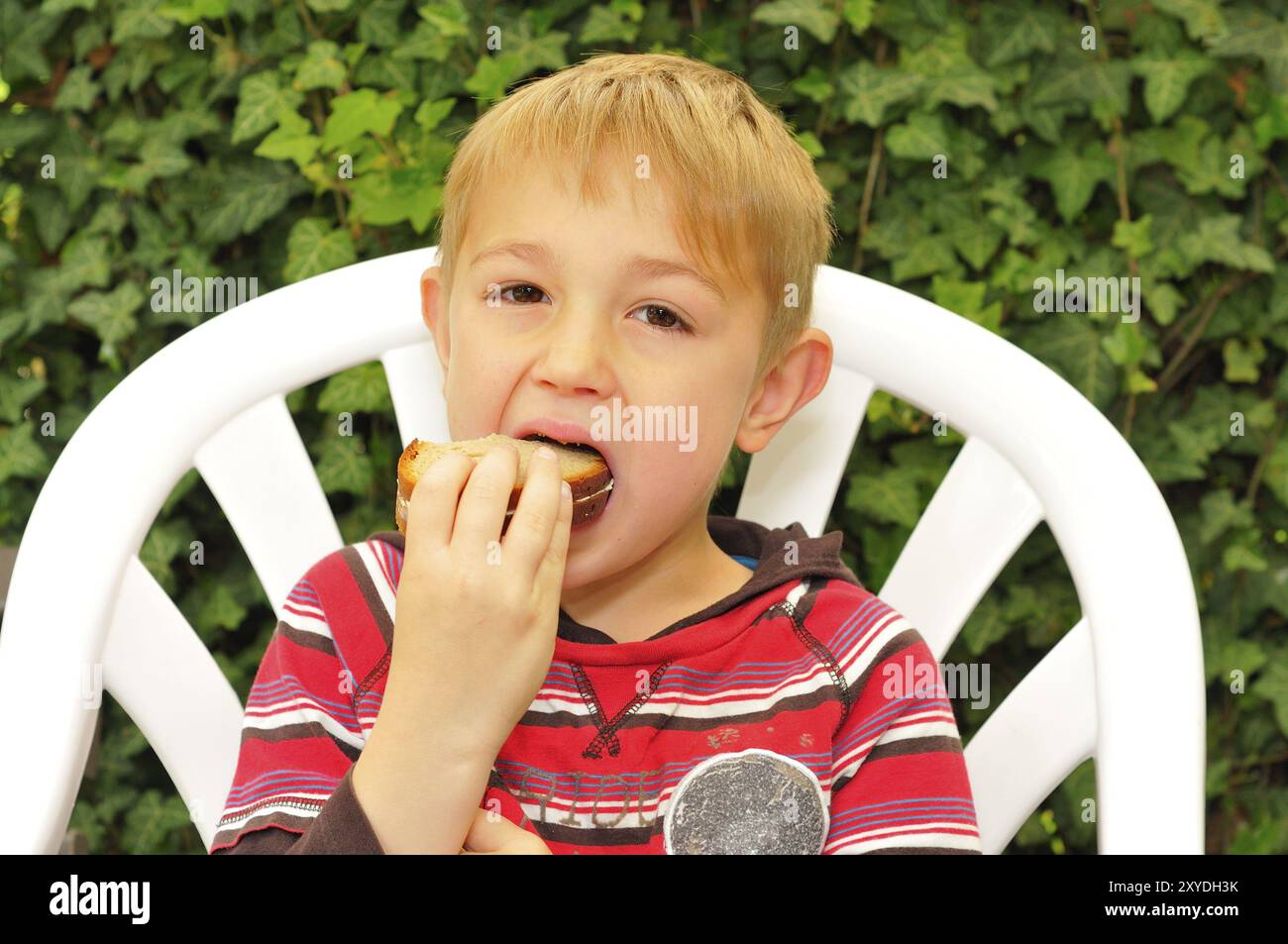 Child bites into a sandwich Stock Photo - Alamy