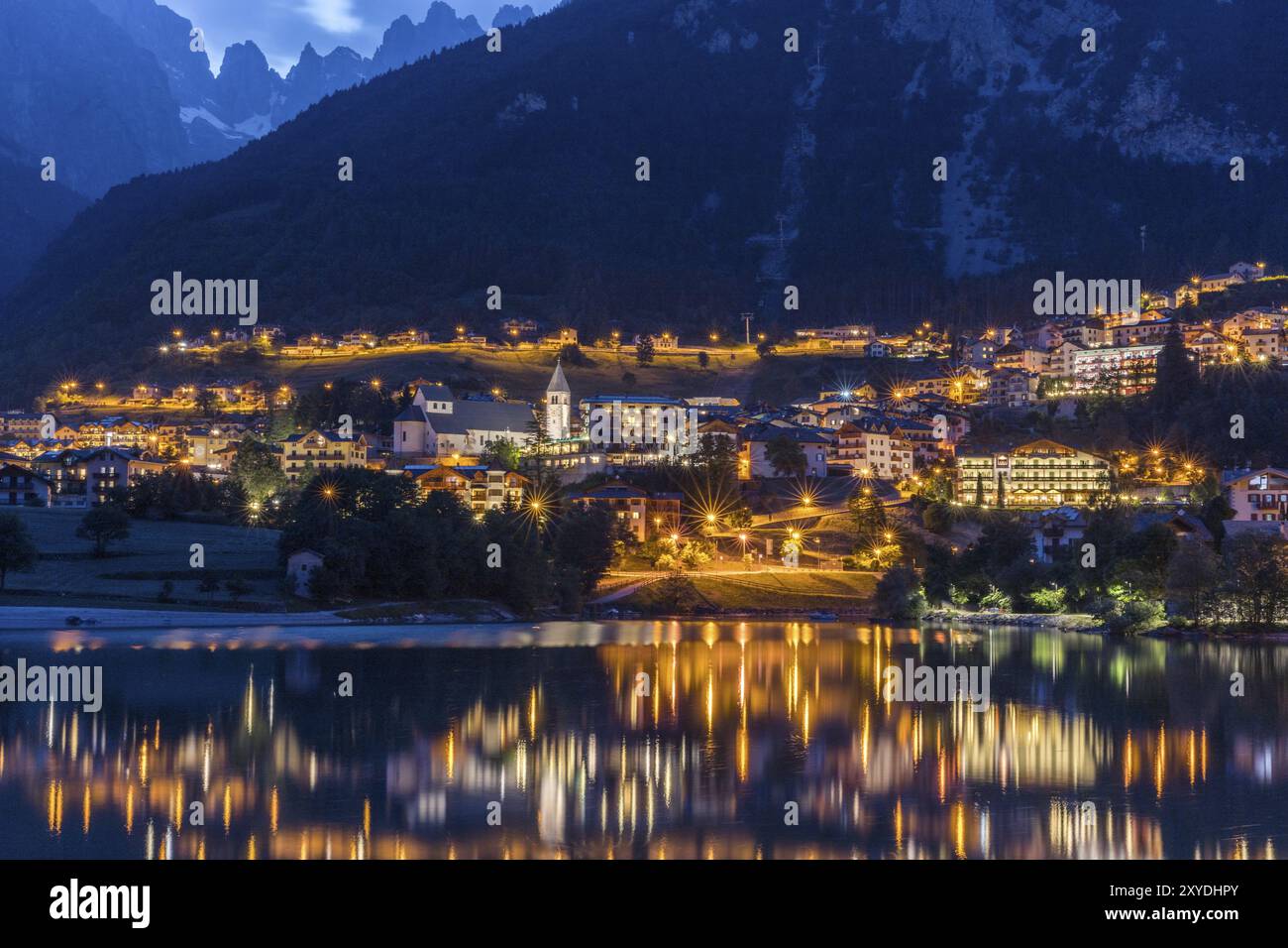 Lake Molveno is nestled between mountains in the Dolomites, Italy ...