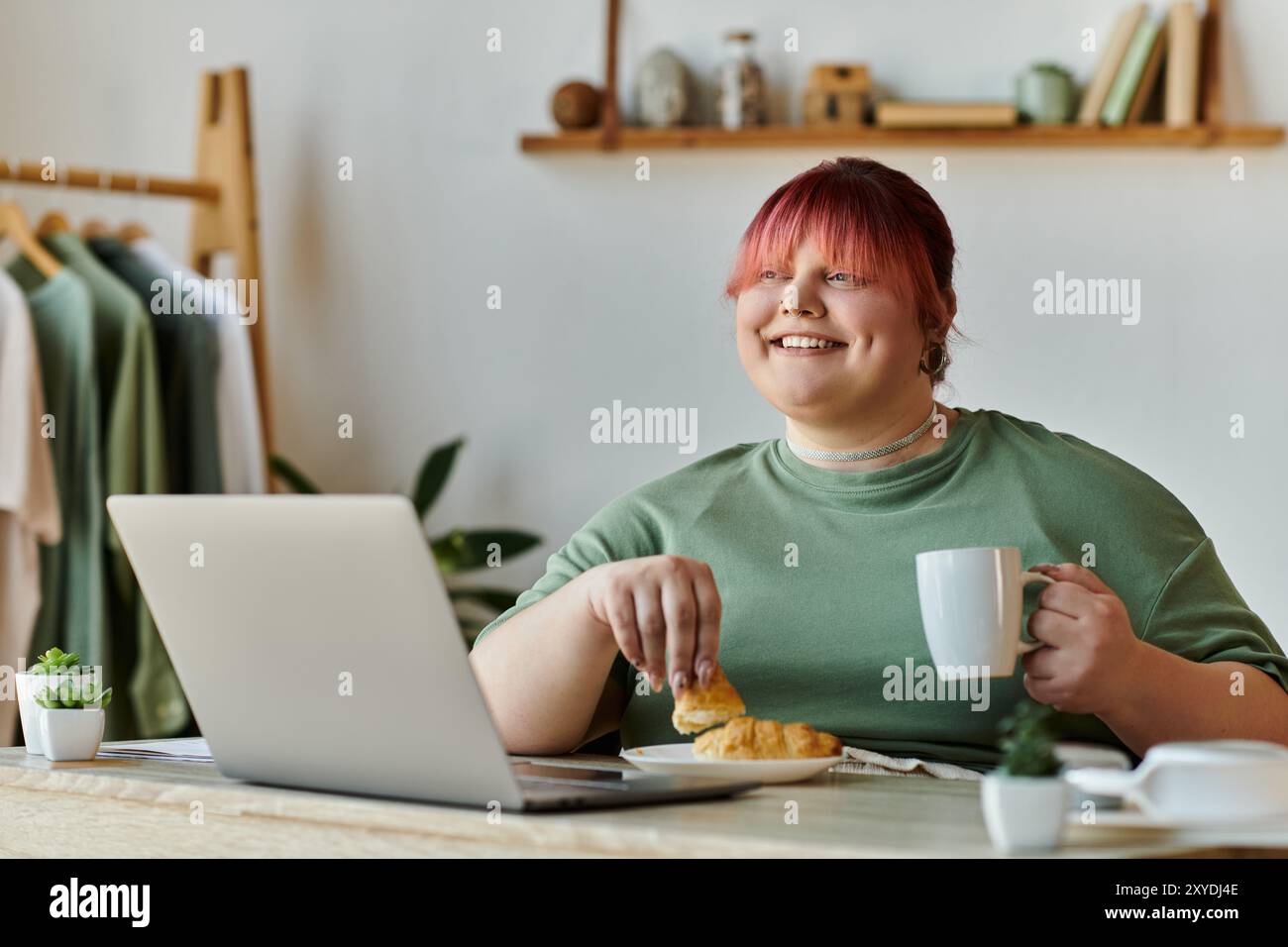 Woman smiles at table, enjoying a snack and coffee, gazing away Stock ...