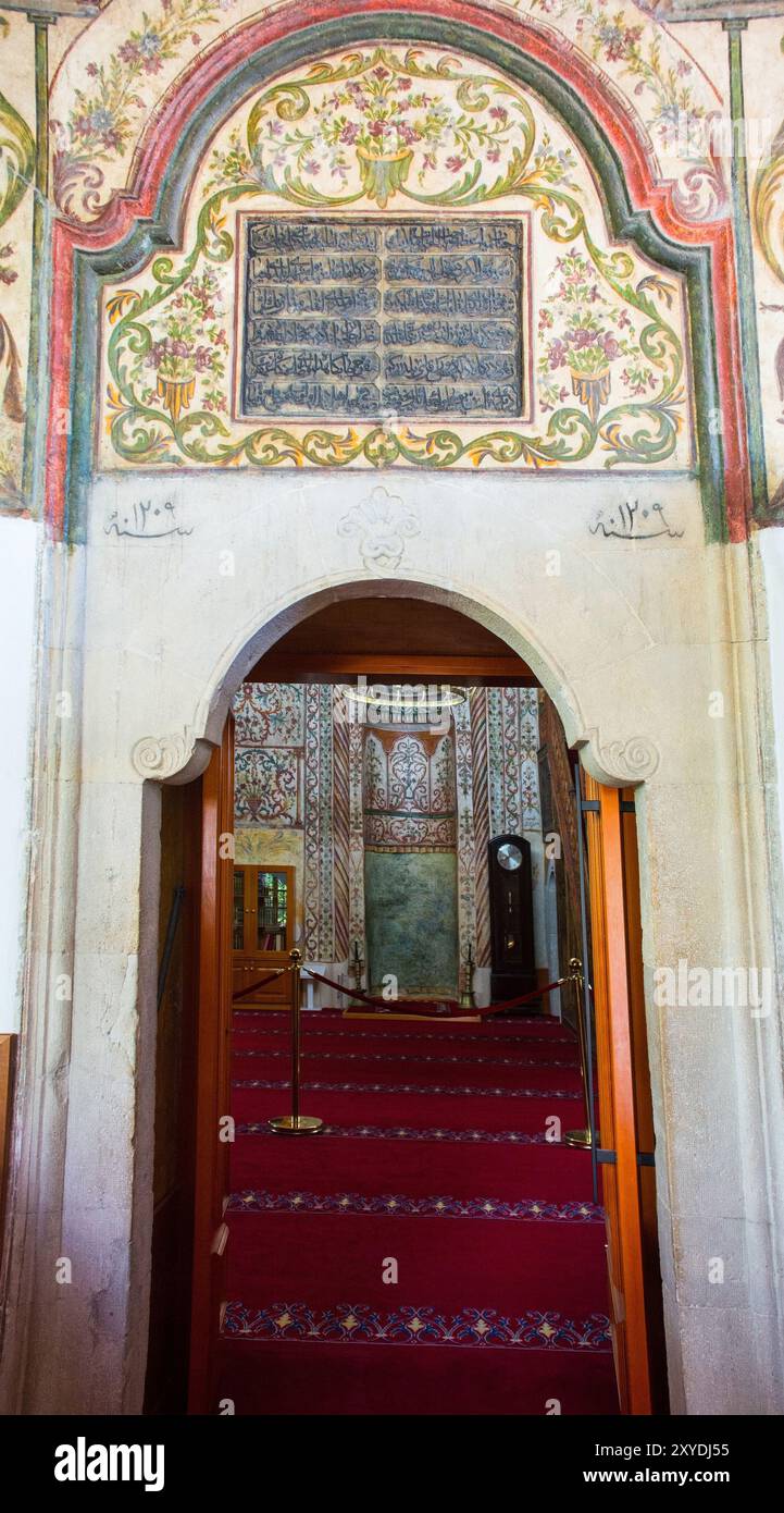 The entrance to Ethem Bey Mosque in Tirana, Albania. Archway decorated ...
