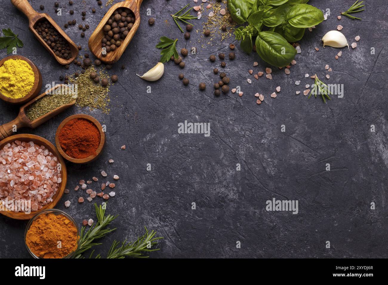 Spices and herbs over black stone background. Top view with free space ...