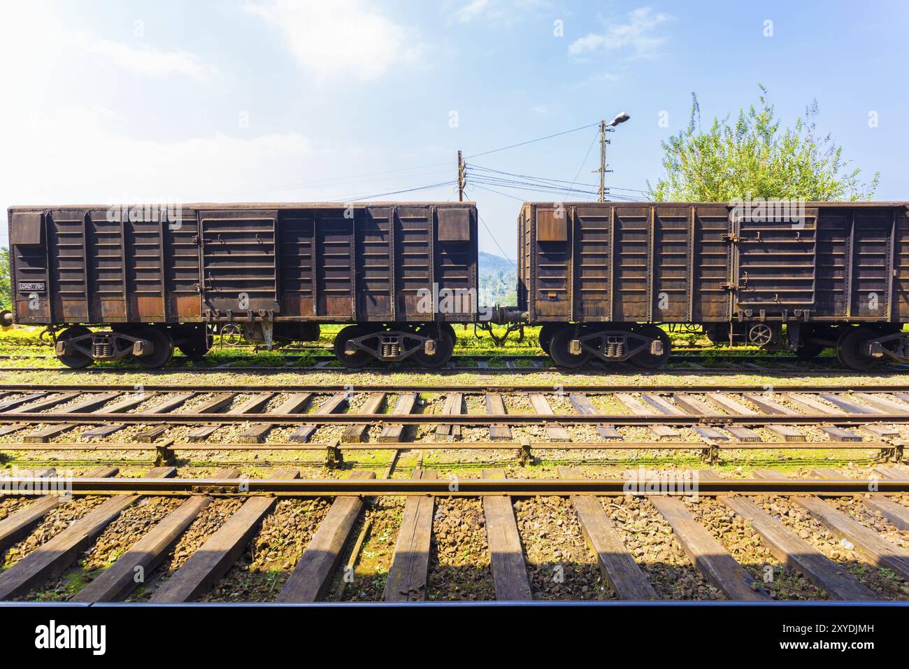 Side view of an old stationary rusted cargo carriage car sitting parked ...