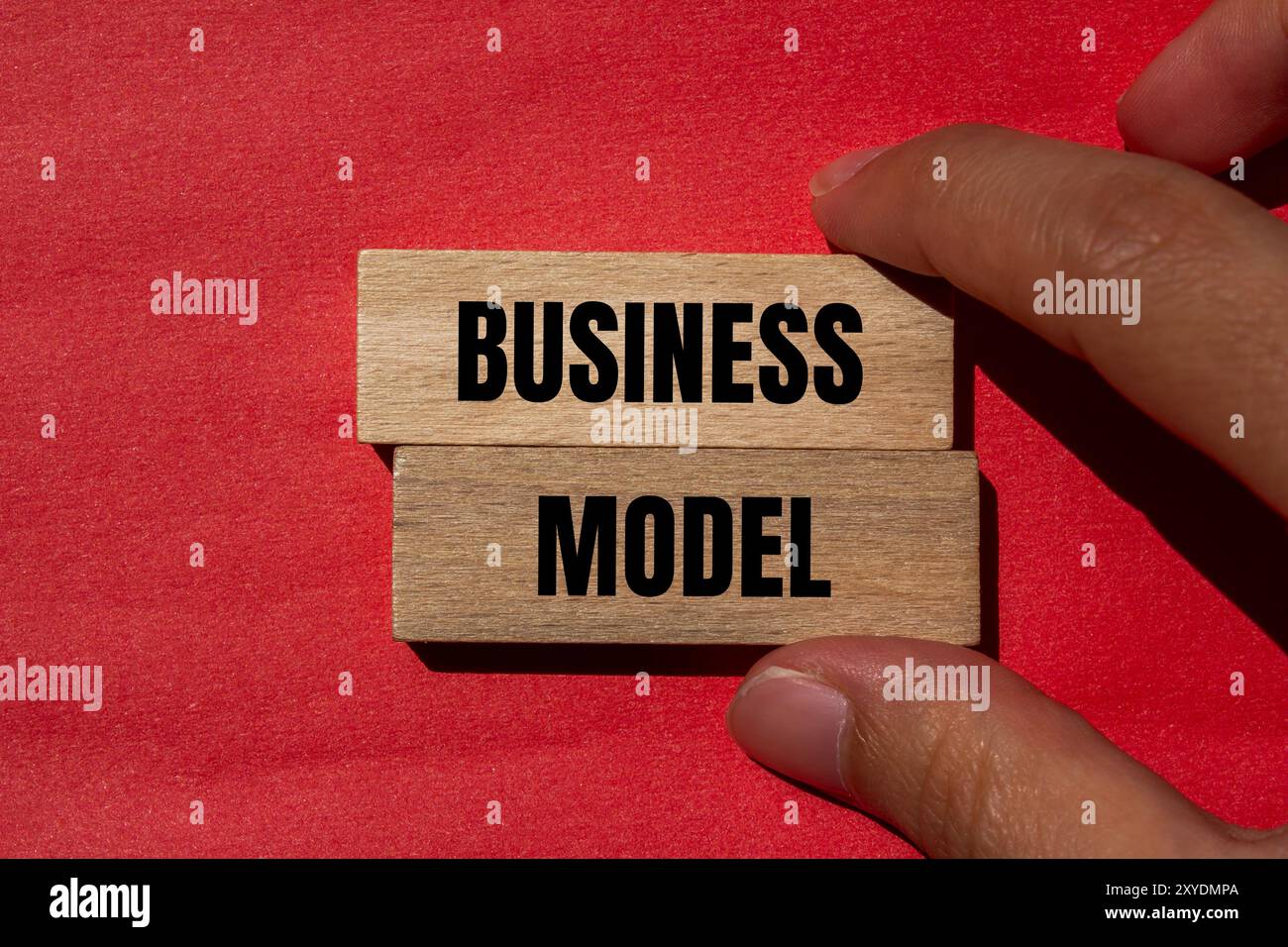 Business model message written on wooden blocks with red background ...
