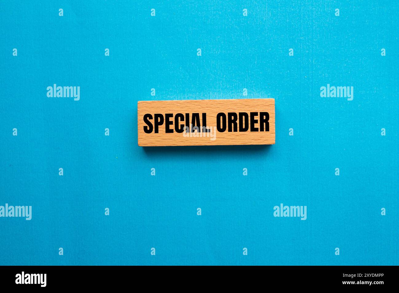 Special order message written on wooden block with blue background ...