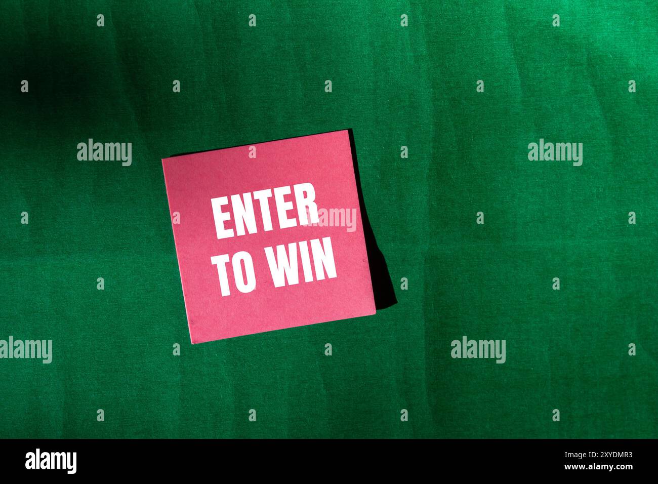 Enter to win message written on pink paper with green background ...