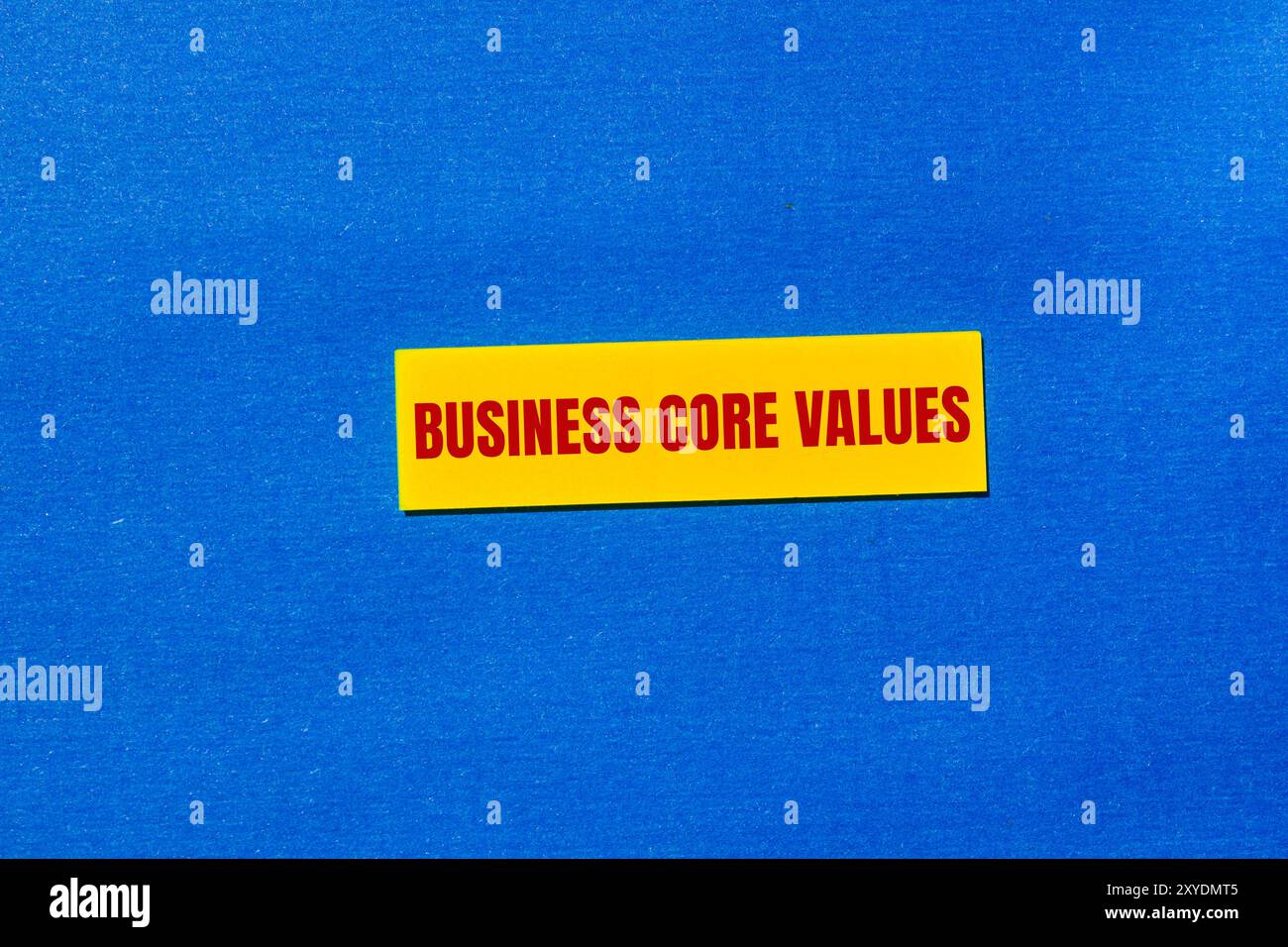 Business core values message written on yellow sticker with blue ...
