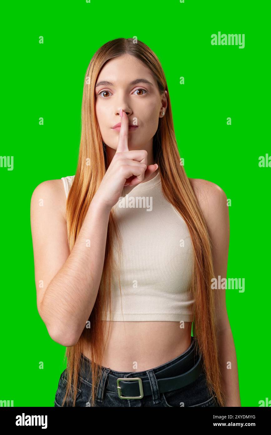 Young Woman Gesturing Silence in Front of Green Screen Stock Photo - Alamy