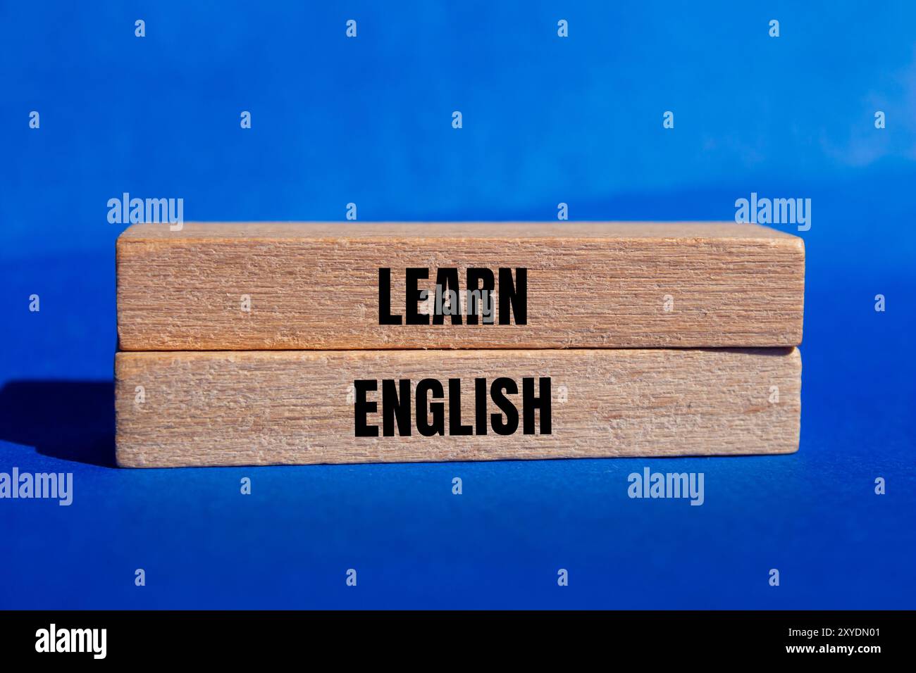 Learn english message written on wooden blocks with blue background. Conceptual learn english ...