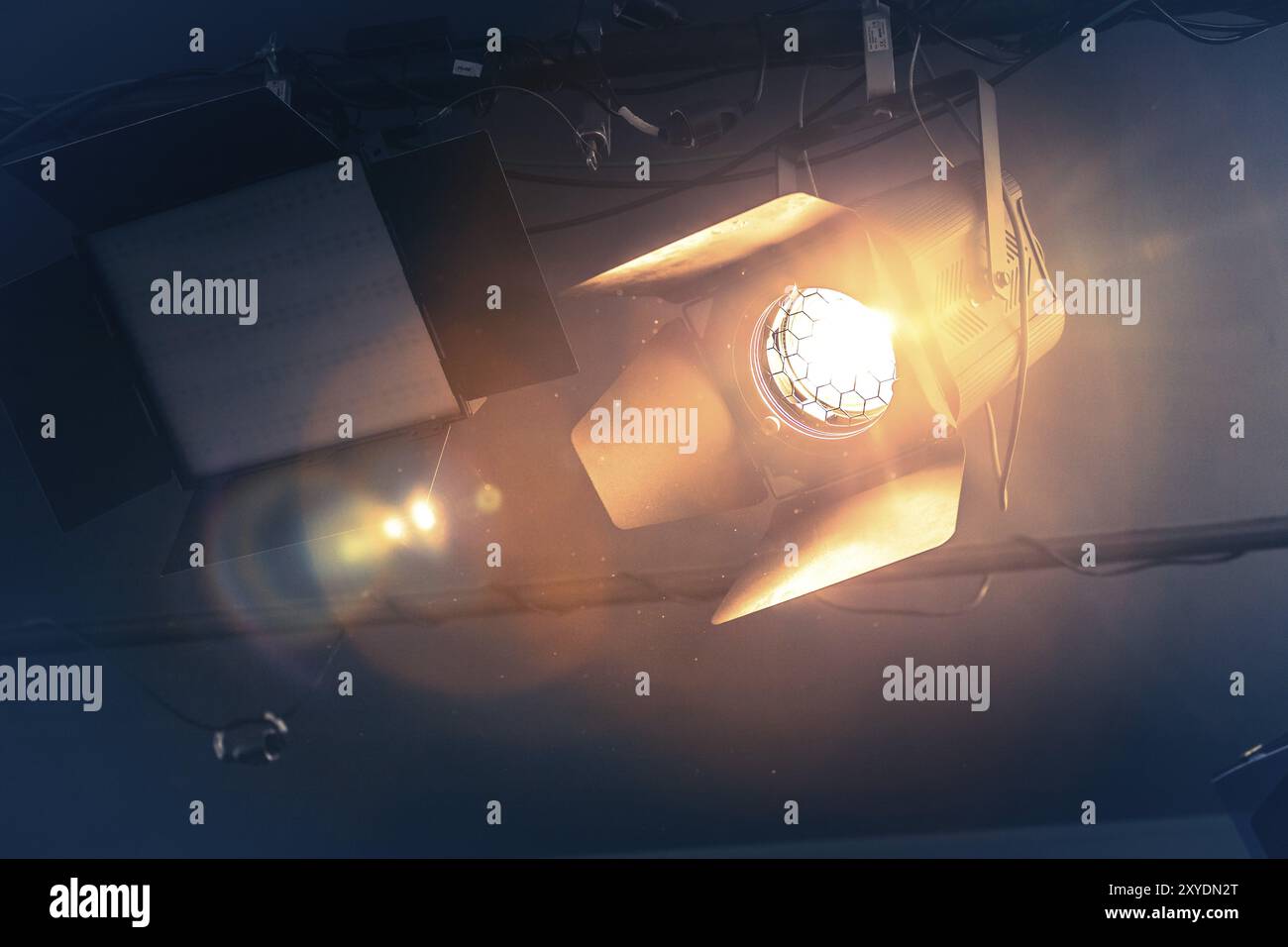 Professional orange studio spotlight hanging on the ceiling Stock Photo ...