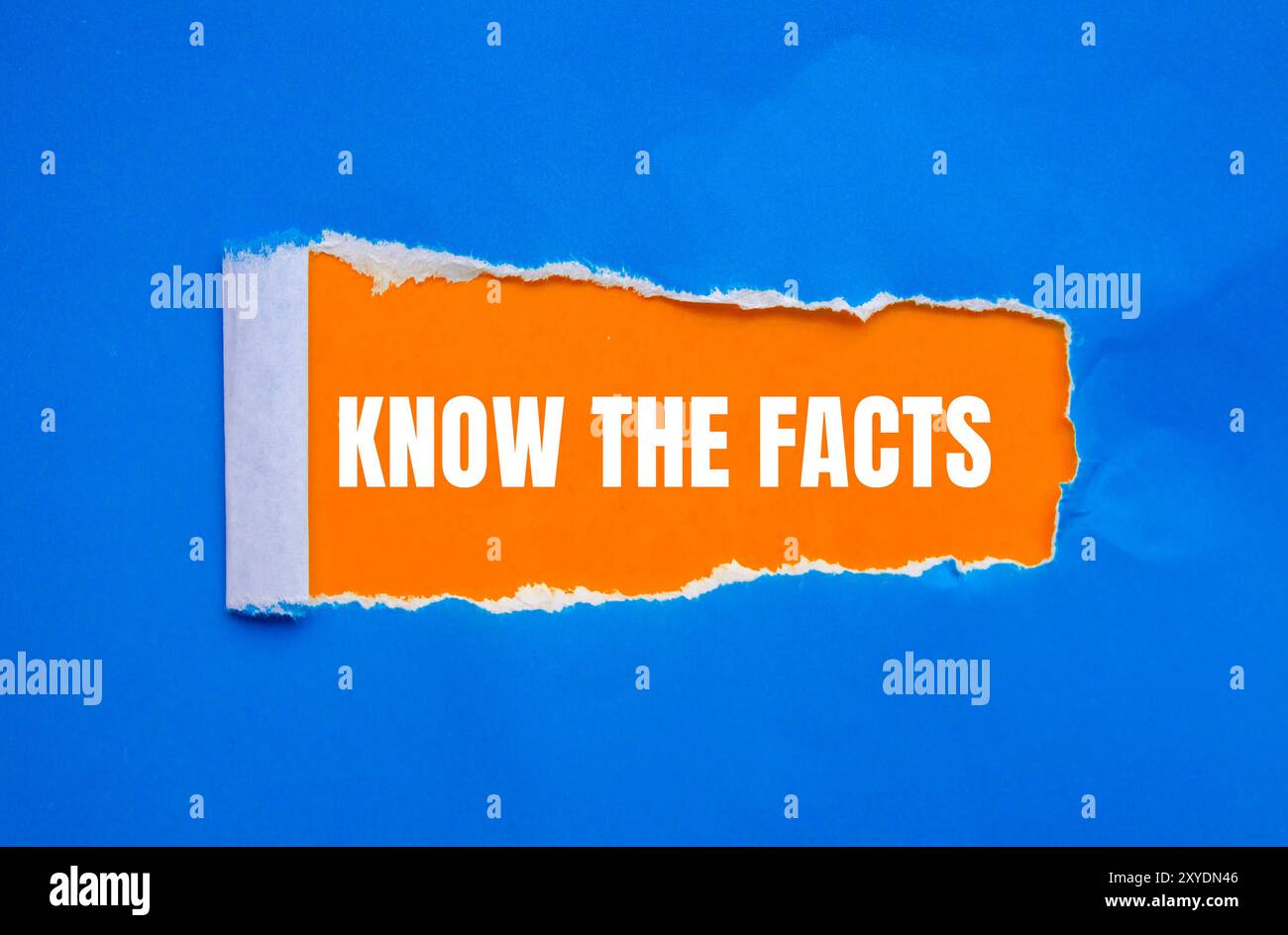 Know the facts message written on ripped torn blue paper with orange ...