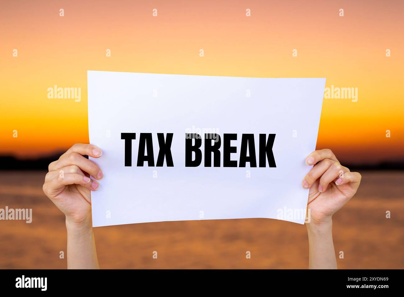 Tax break message written on white paper with blurry lake background ...