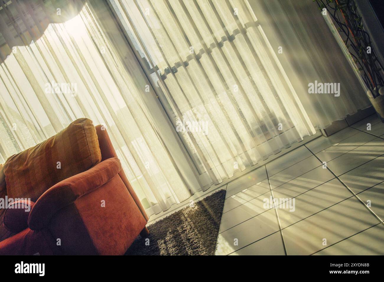 The rising sun shines through the window into a living room Stock Photo ...