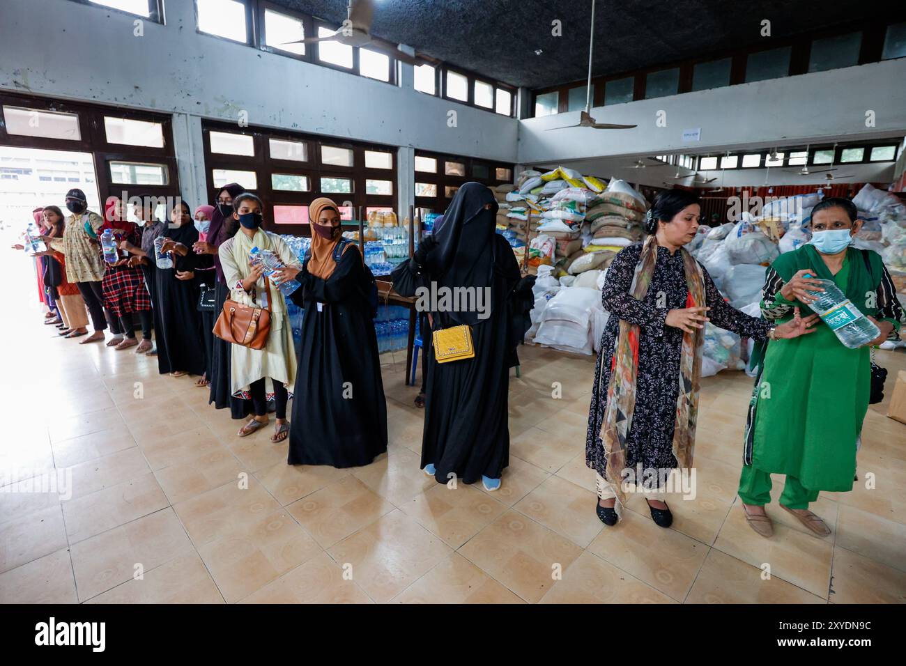 Student volunteers stocking, sorting and packaging relief materials ...
