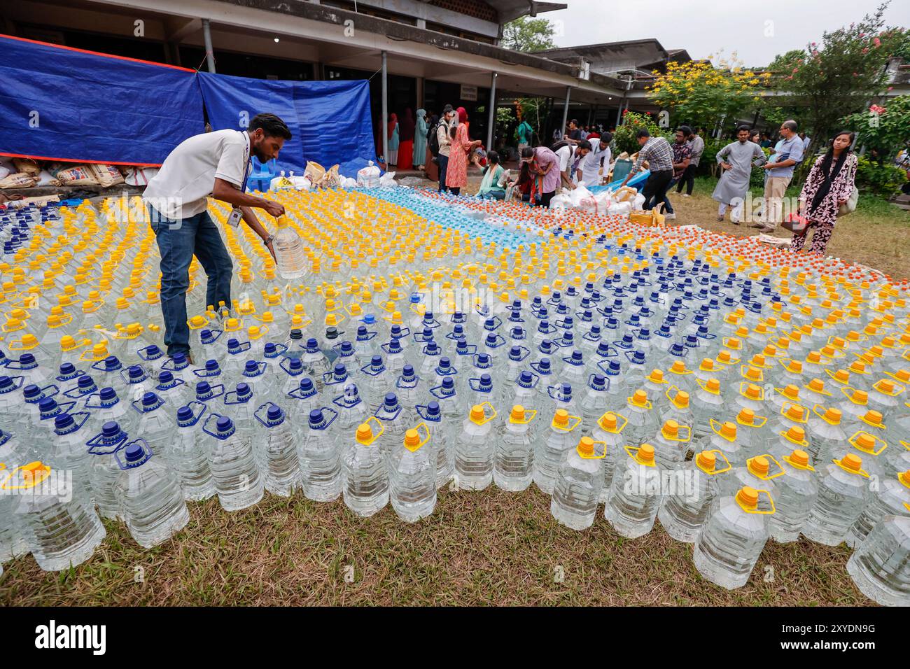 Student volunteers stocking, sorting and packaging relief materials ...