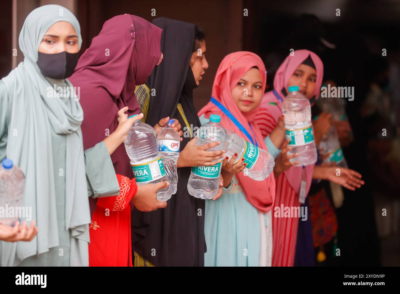 Student volunteers stocking, sorting and packaging relief materials ...