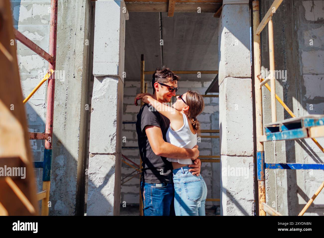 Young married couple checking their future house under construction ...