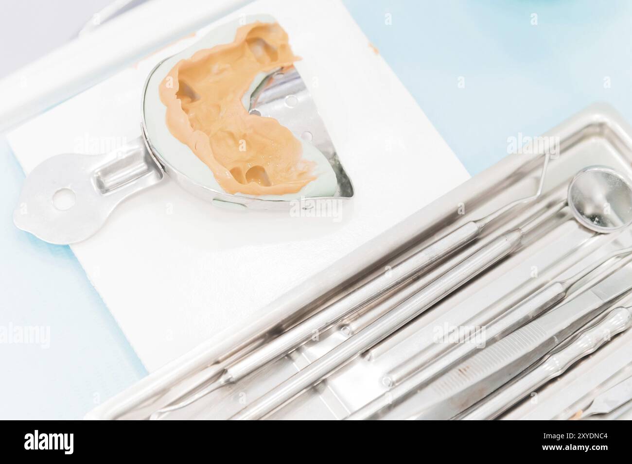 Close-up of a common stamotological instrument next to a metal form for ...