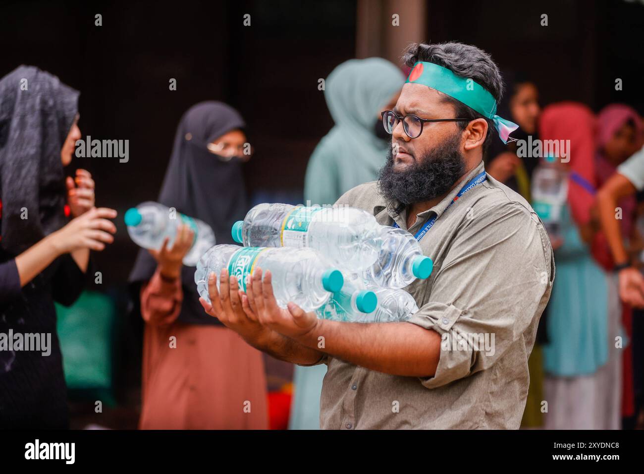 Student volunteers stocking, sorting and packaging relief materials ...