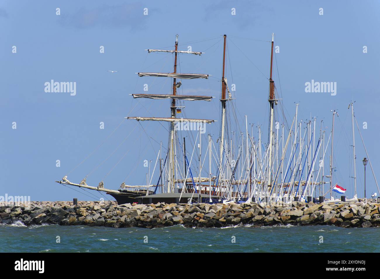 Three-masted topsail schooner moored behind the pier of a marina Stock ...