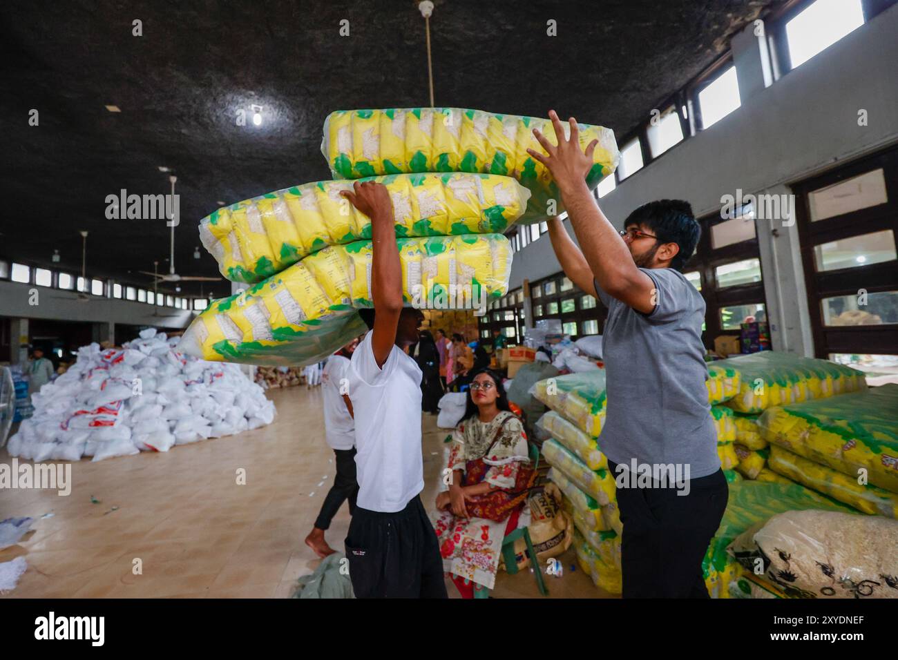 Student volunteers stocking, sorting and packaging relief materials ...