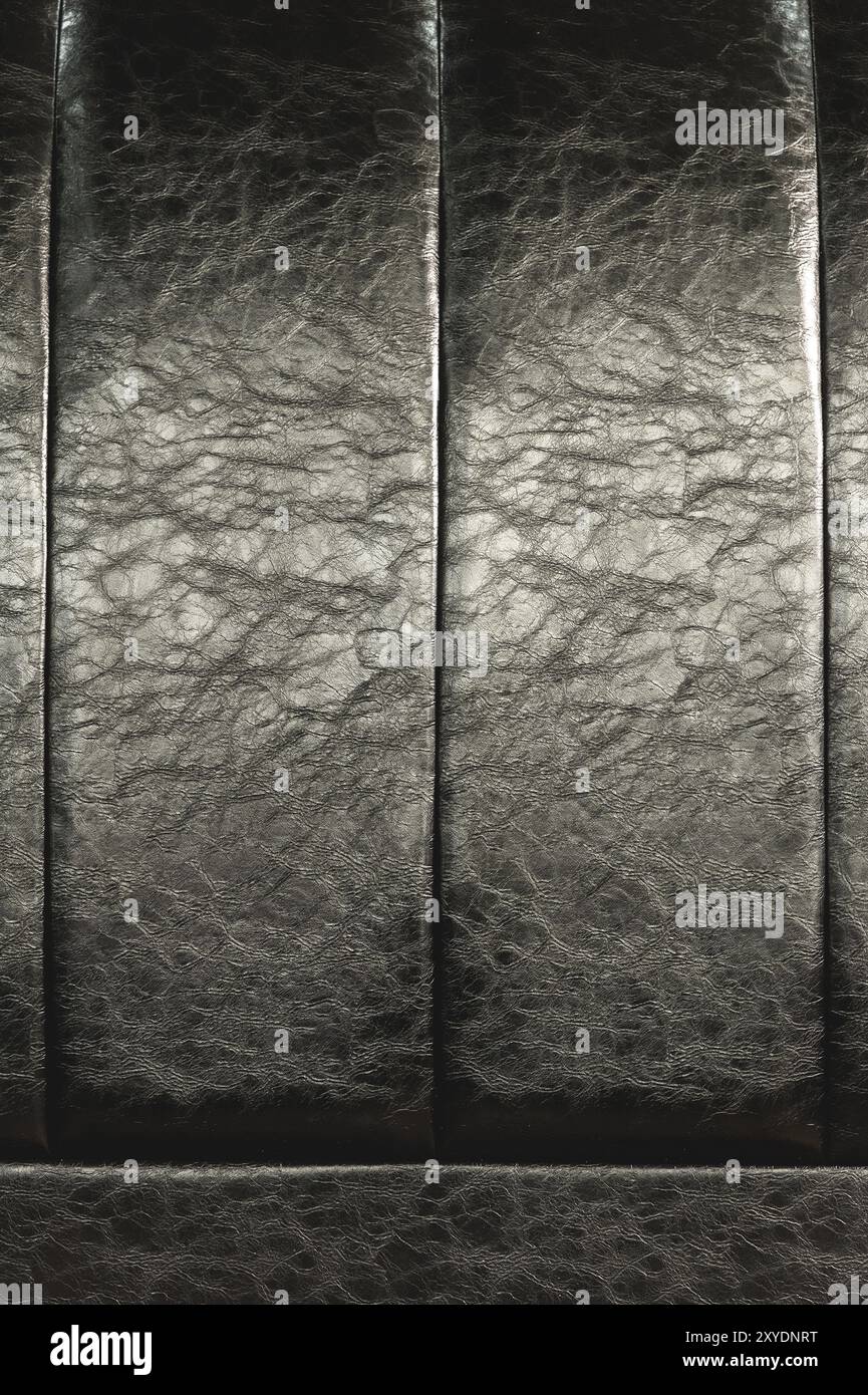 The texture of the real leather on the back of the bed. Vertical ...