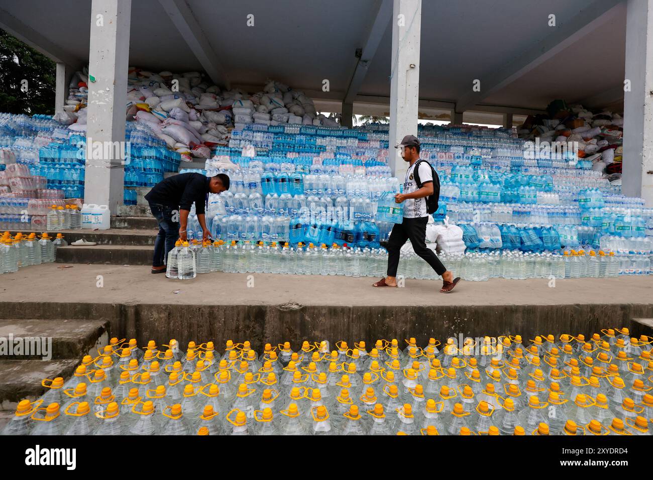 Student volunteers stocking, sorting and packaging relief materials in ...