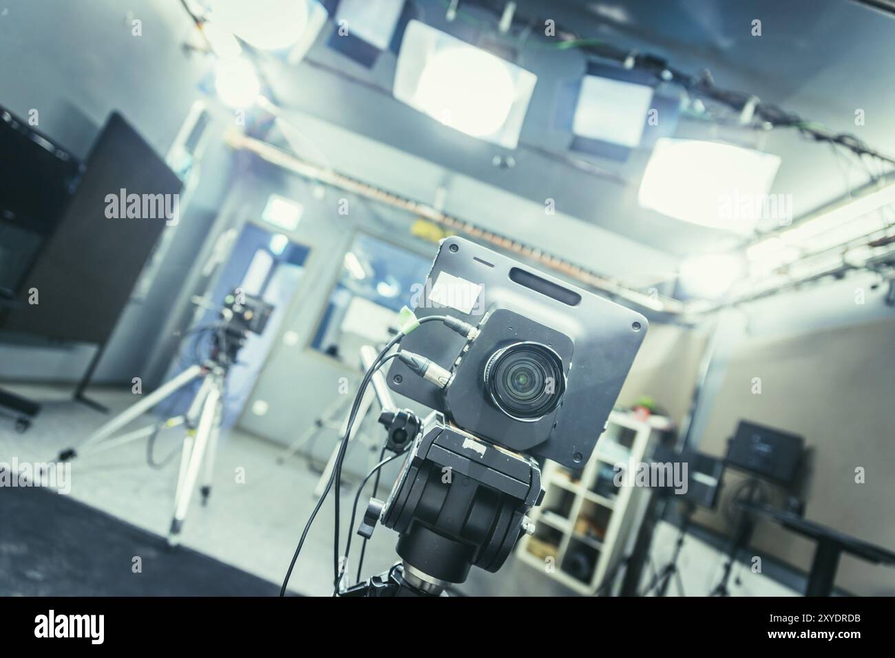 Lens of a film camera in an television broadcasting studio, spotlights ...