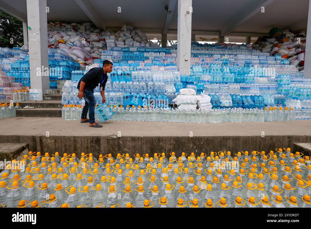 Student volunteers stocking, sorting and packaging relief materials in ...