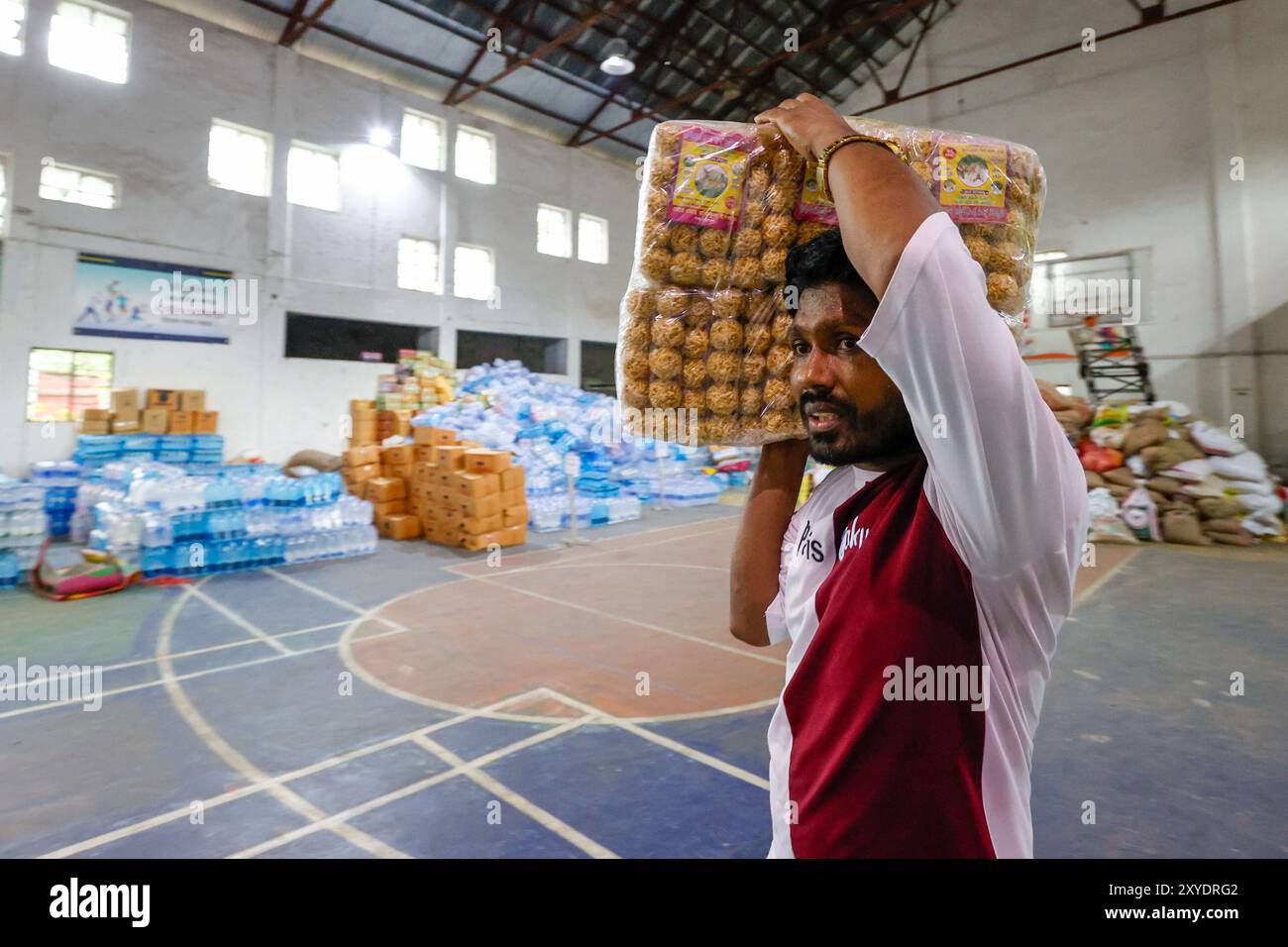 Student volunteers stocking, sorting and packaging relief materials in ...
