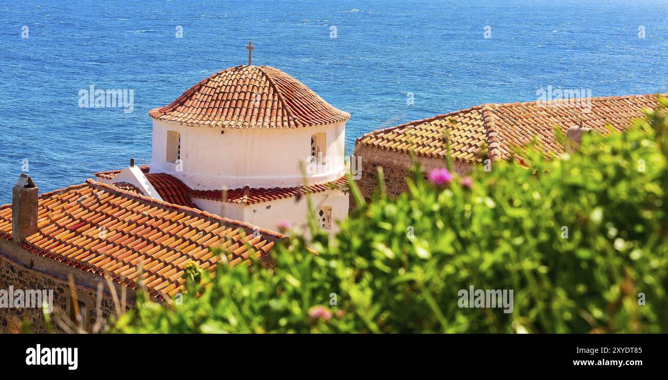 Monemvasia church, old red brick houses, roofs in ancient town and blue ...