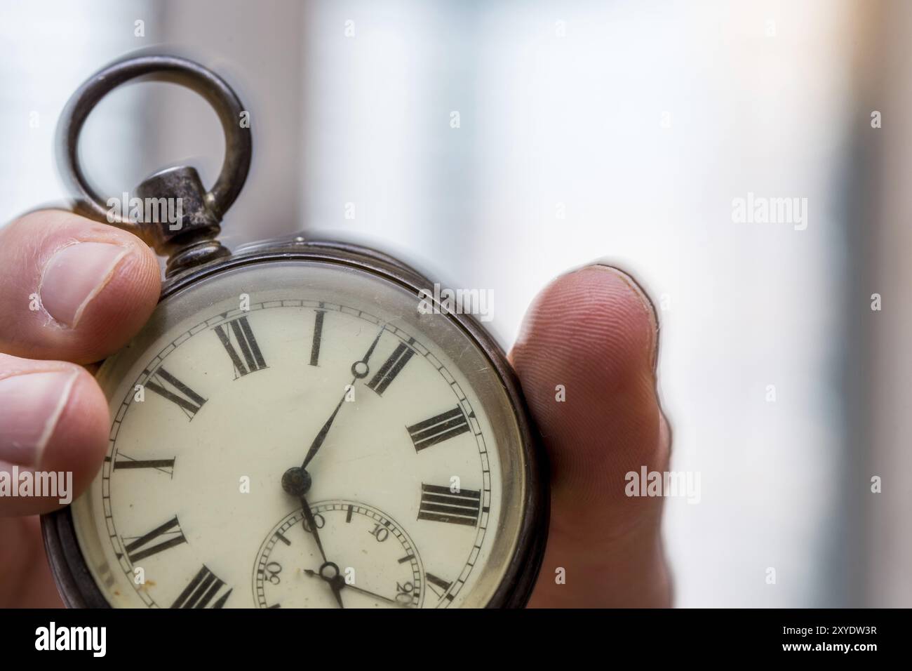Time goes by: Man is holding a vintage watch in his hand, business ...