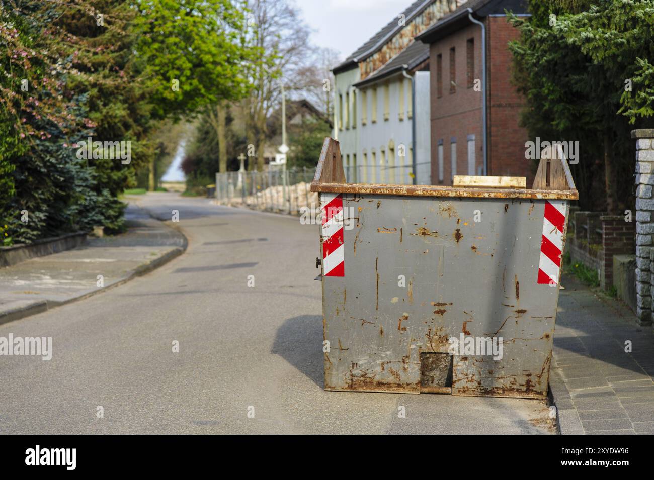 Container for building rubble stands at the roadside in a village Stock ...