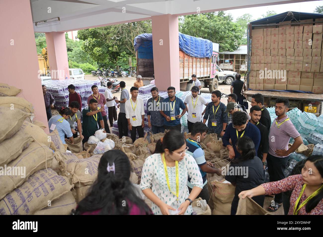Government officials and workers are preparing food packets to be ...