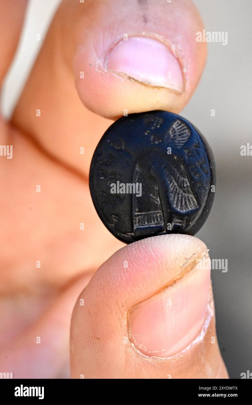 Archeologist Rom Navot from the Israel Antiquities Authority, holds a ...