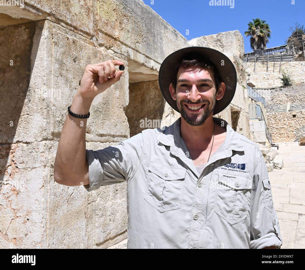 Archeologist Rom Navot from the Israel Antiquities Authority, holds a ...