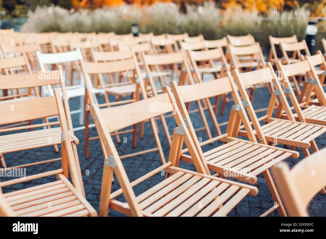 Empty wooden chairs left outdoors after conference or wedding ceremony ...