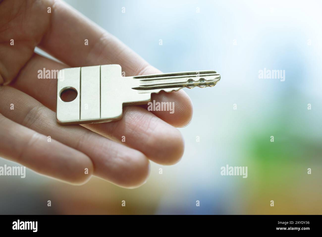 Holding a house key in the hand: New home and property Stock Photo - Alamy