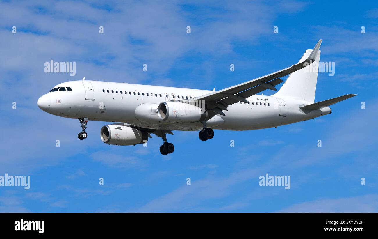 DAT Airways Airbus A320 with clear white livery landing with a blue sky ...