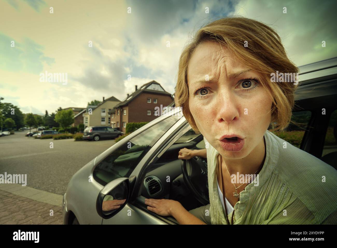 Angry car driver sticks her head out of the window Stock Photo - Alamy