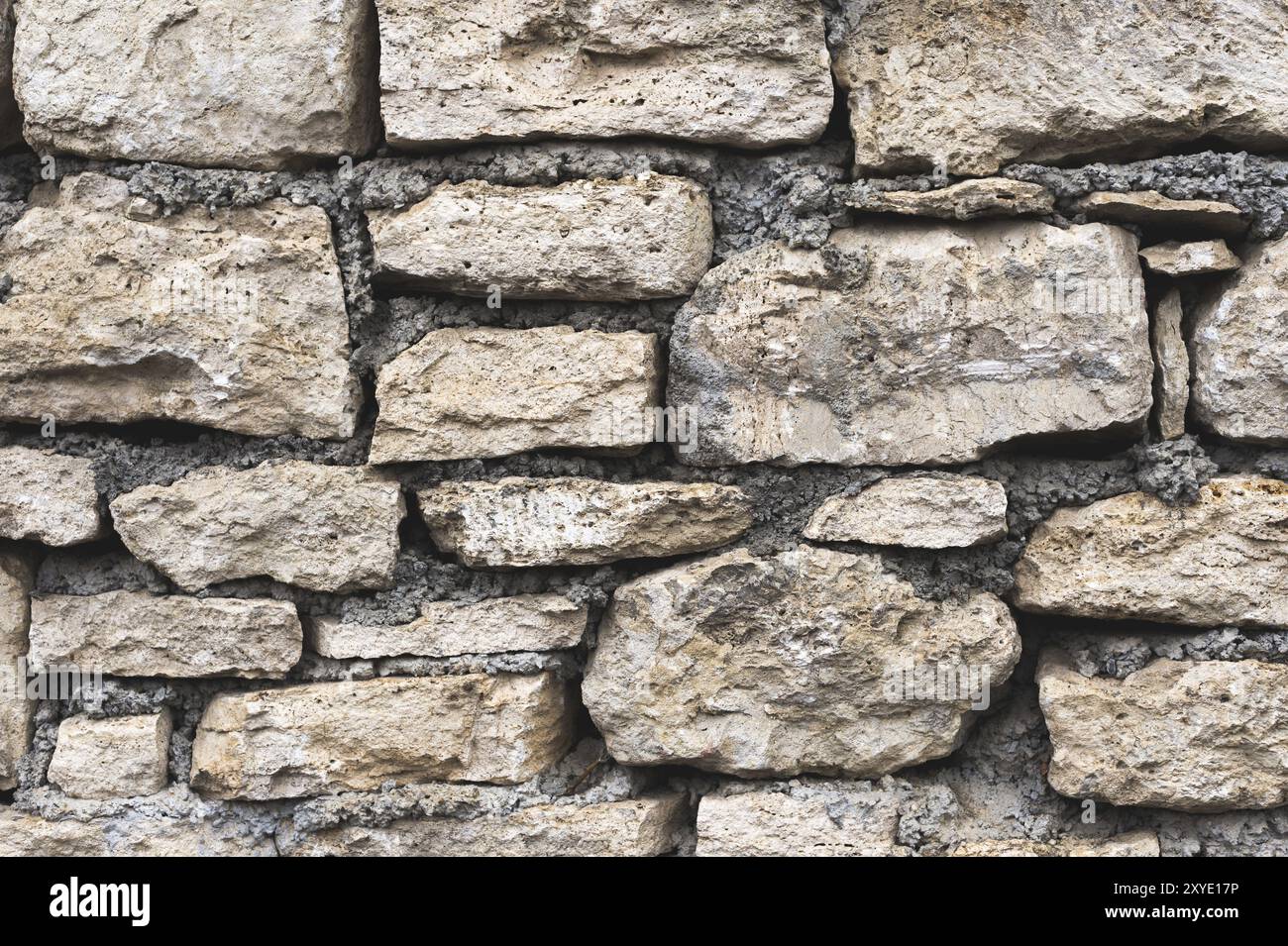 Close-up textured background is an irregular natural stone wall made of ...