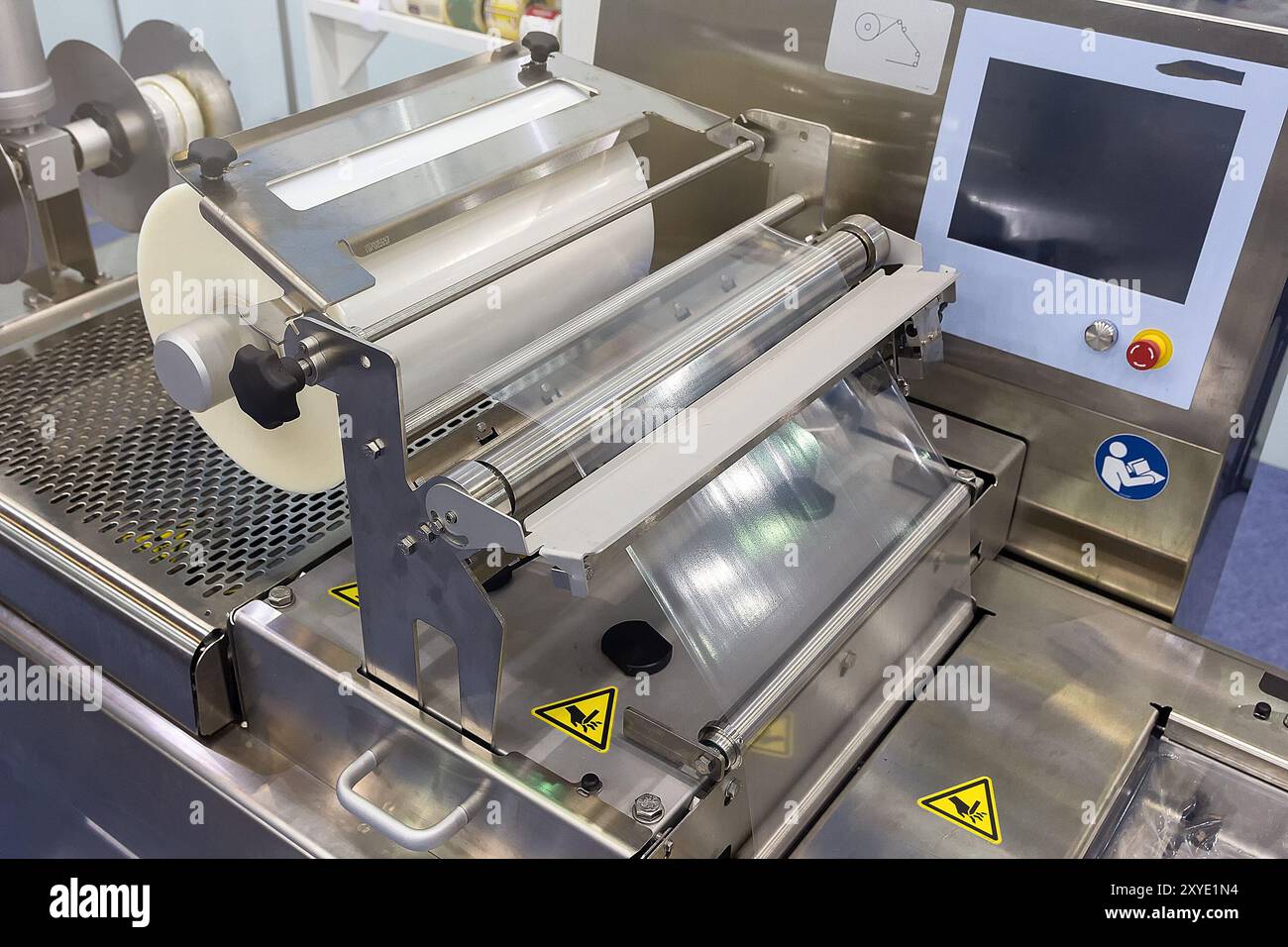 Roll of plastic packaging film on the automatic packing machine in food ...