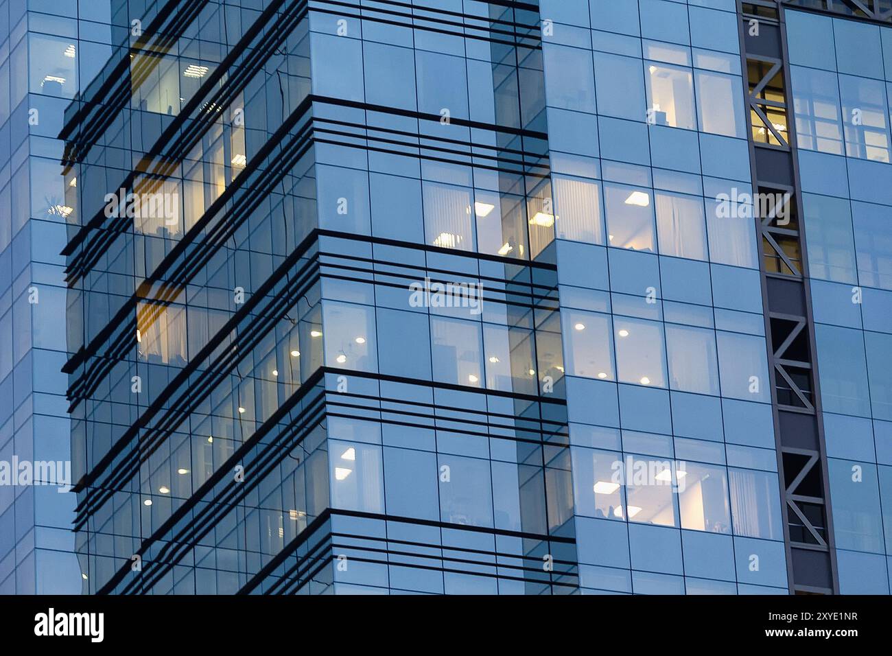 Office windows lights, high-rise glass skyscraper business building in ...