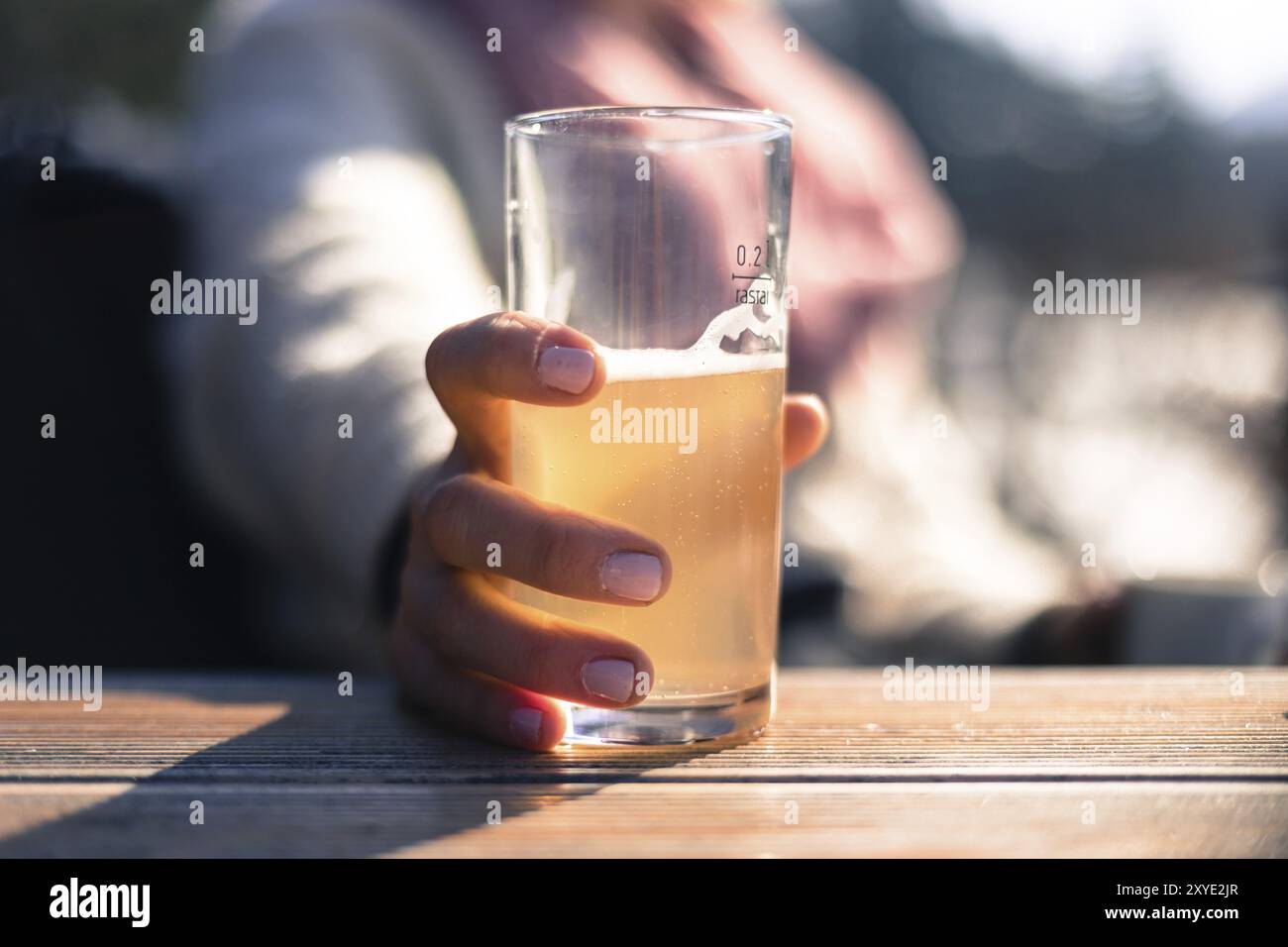 Woman is holding a glass lemonade in her hand, cut-out Stock Photo - Alamy