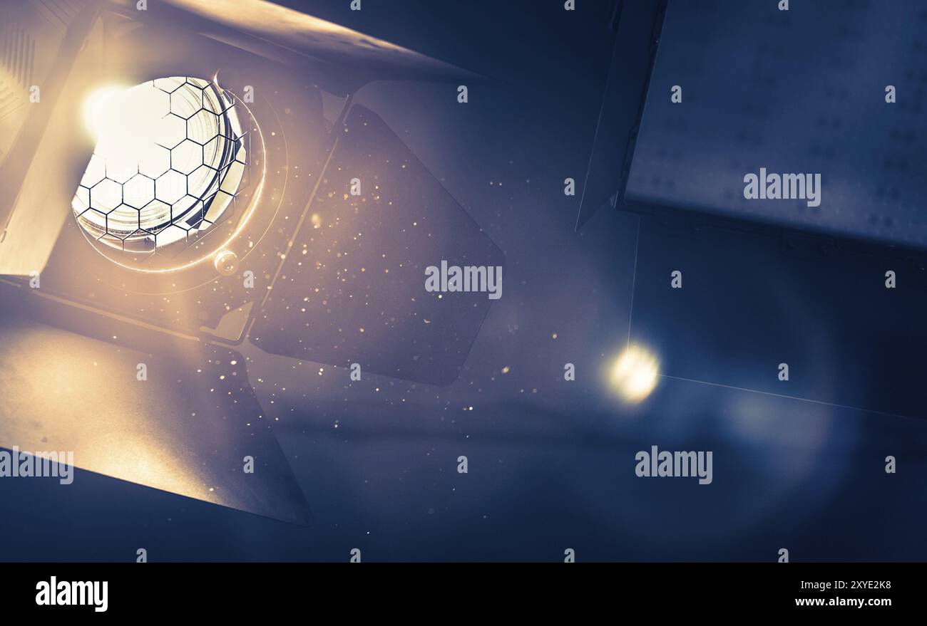 Professional orange studio spotlight hanging on the ceiling. Lighted ...