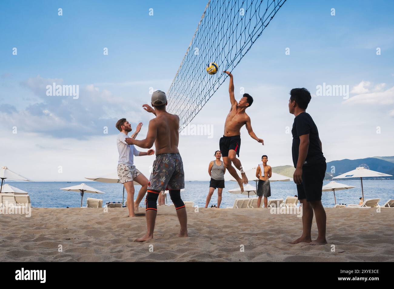 Teams with multinational players play beach volleyball on the beach by ...
